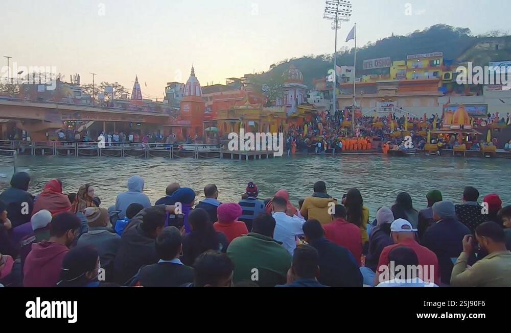 people gathered at ganges aarti religious pryer at evening at river ...