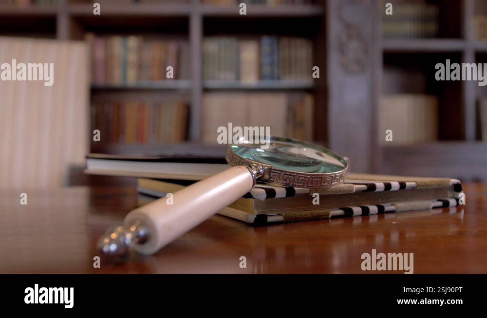 Archaeologist's Magnifying Glass on an Old Book in a Office with a ...