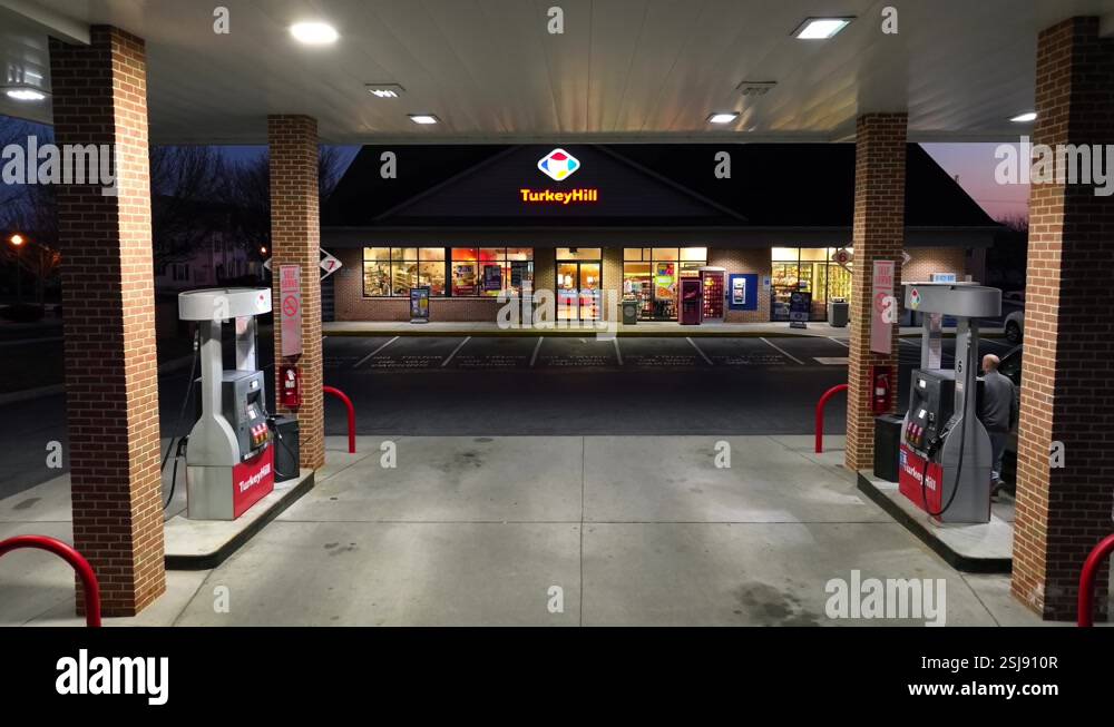 Turkey Hill convenience store and gas station. Man pumps gasoline in ...