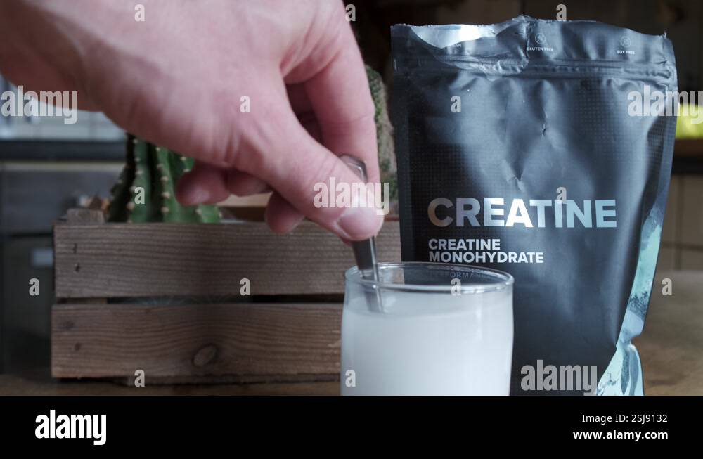 Close up of a hand mixing creatine monohydrate in a glass 4K slow ...