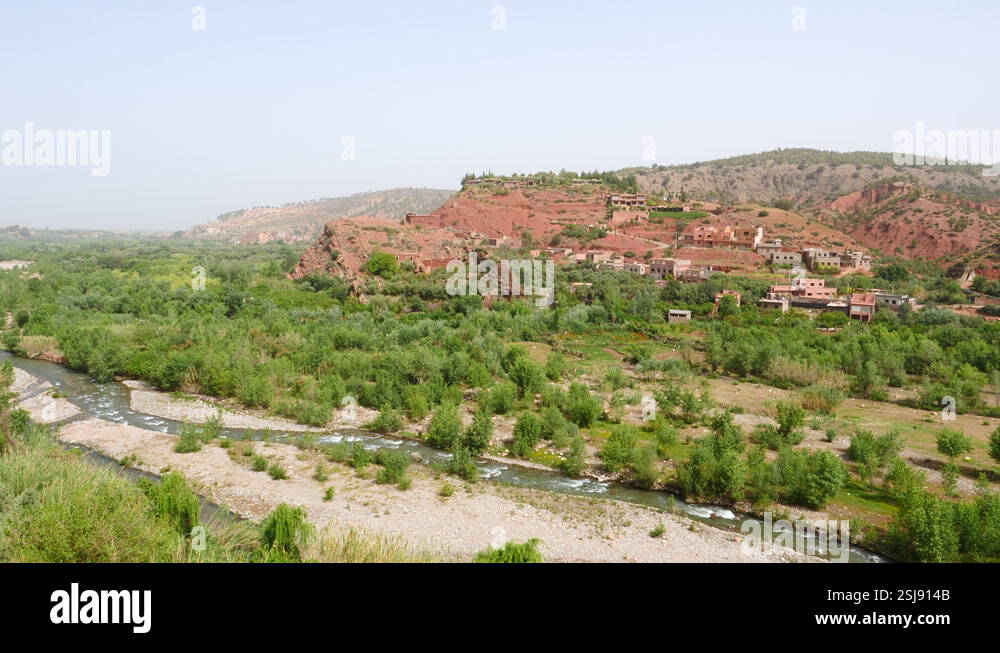 Rural village in valley with lush vegetation and river in Morocco, high ...