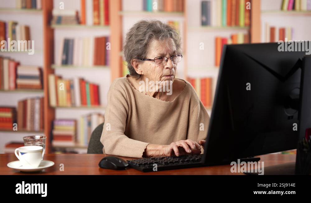 Angry stressed elderly old woman 80s, using computer gets bad news. Mad ...