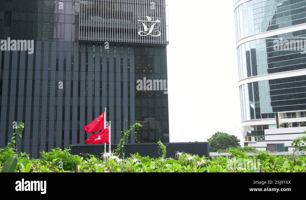 The People's Republic of China and the Hong Kong SAR flags wave on a ...