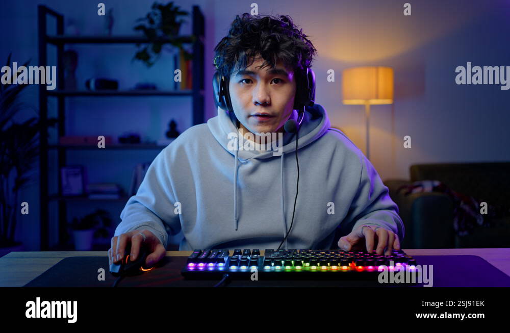 Professional gamer man plays online video virtual computer game with ...