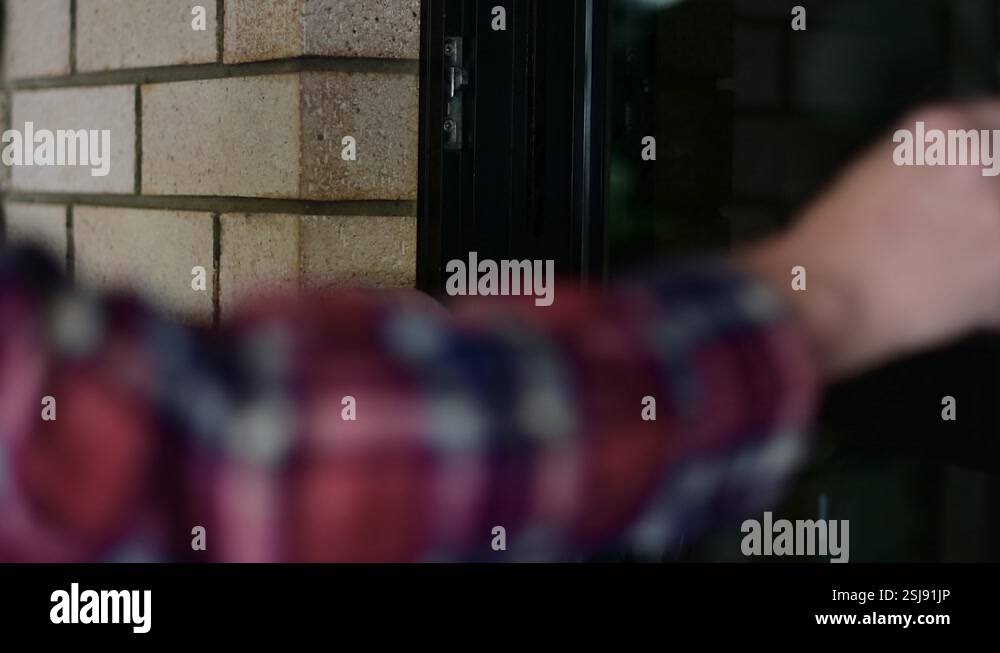 Beautifully shot close up of a lock on a screen door with hands ...