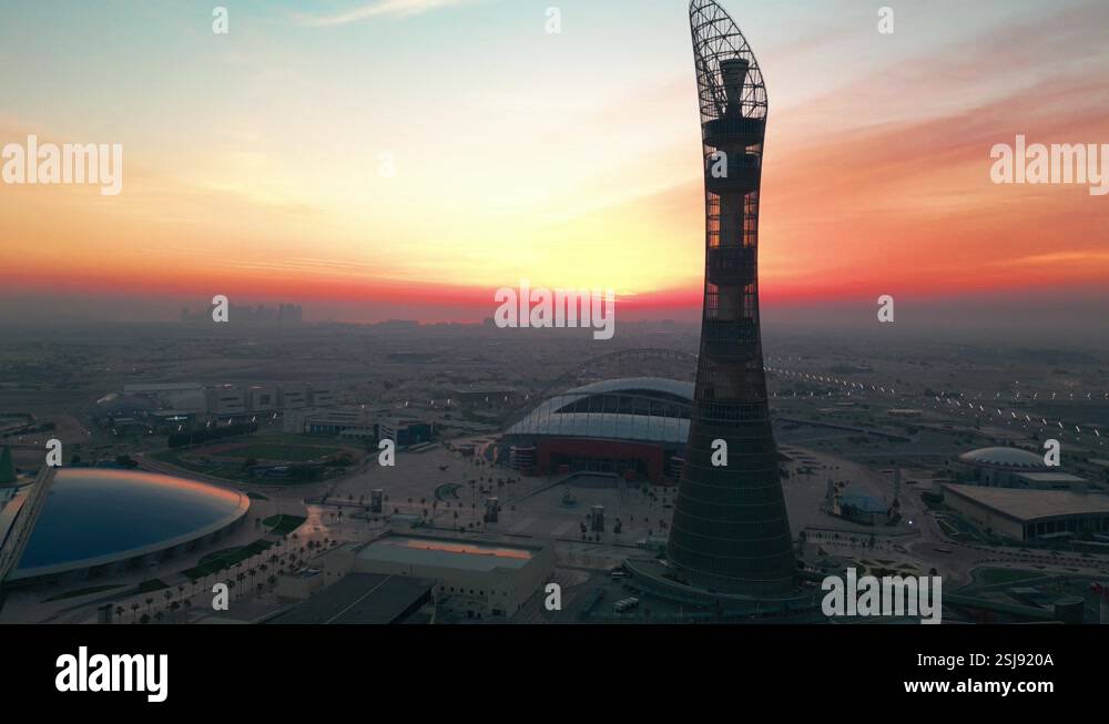 Sunrise aerial of Torch Tower and Khalifa Stadium in Doha, Qatar. Drone ...
