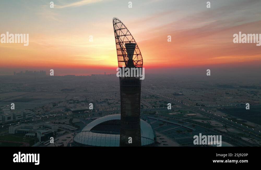 Sunrise aerial of Torch Tower and Khalifa Stadium in Doha, Qatar. Drone ...