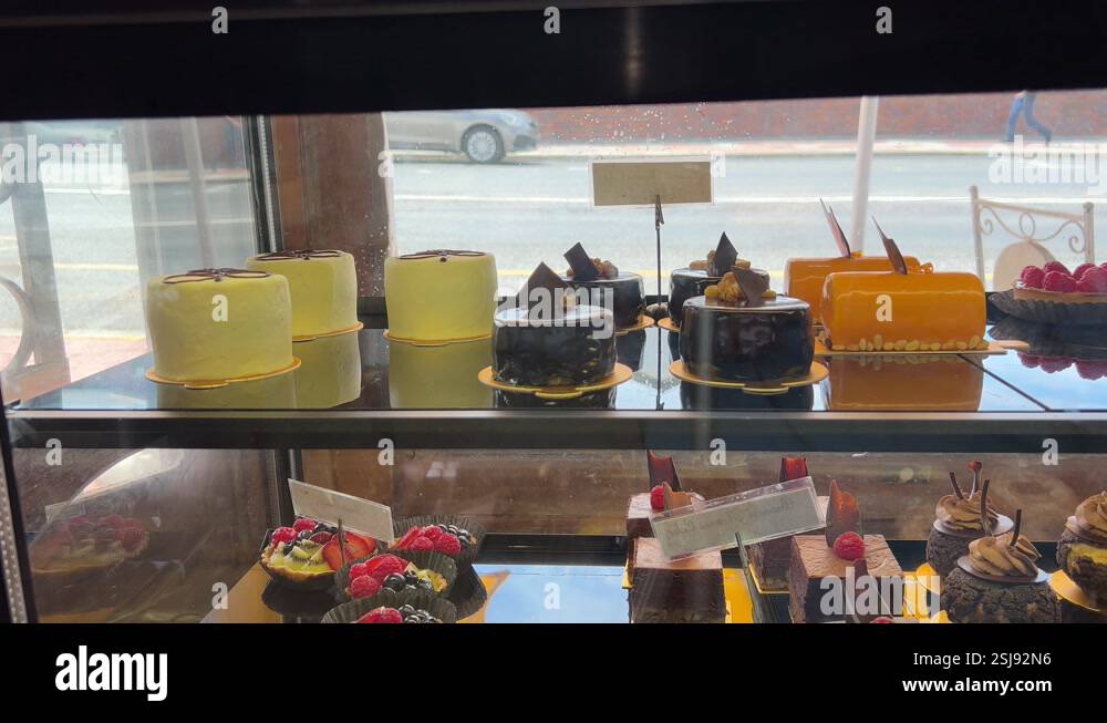 Cakes and pastry bakery window display on a busy road Stock Video ...