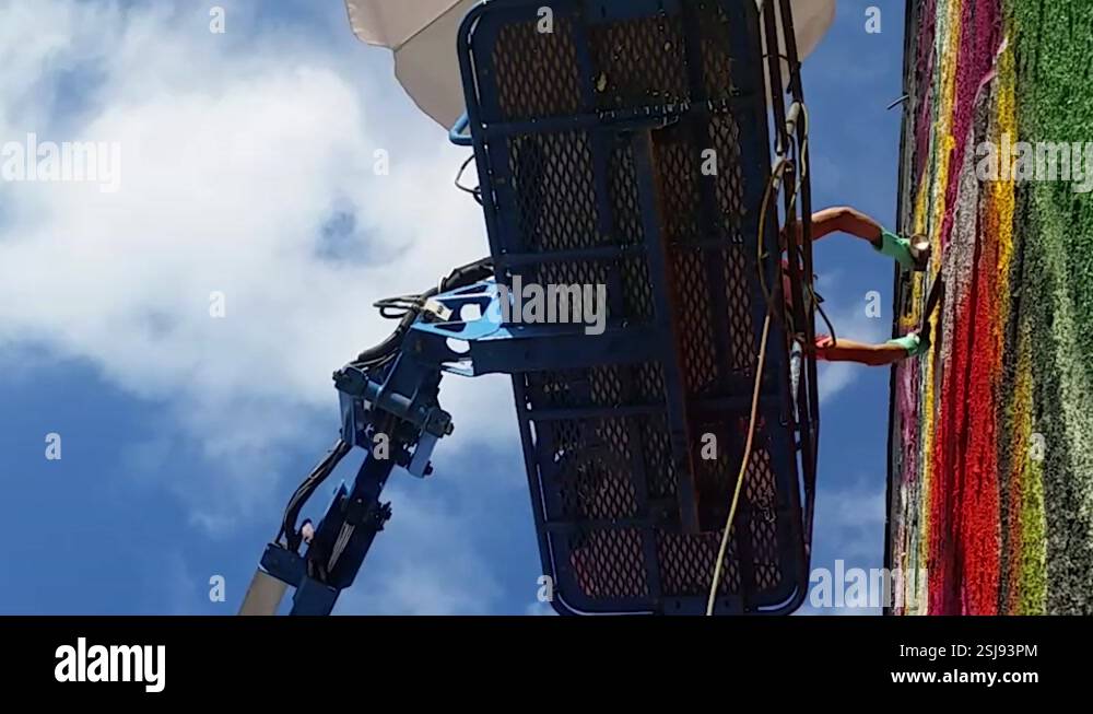 A man works on a graffiti wall high above the ground. Kobra's graffiti ...