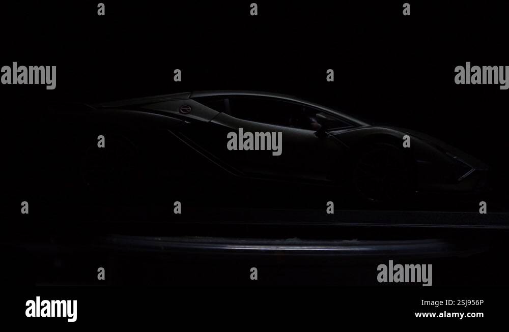 Side-on shot of a beautiful Lamborghini Sian being revealed by a light ...