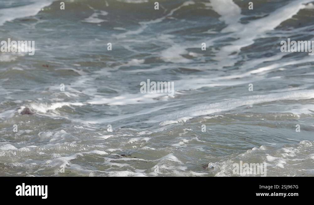 Slow motion waves on the beach in Freshwater on the Isle of White, UK ...