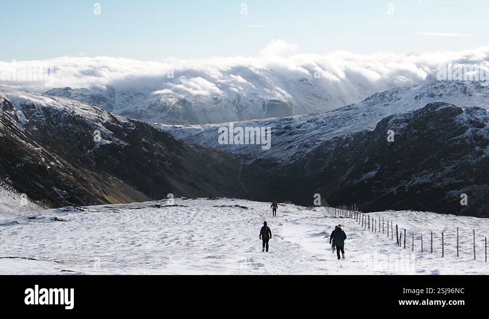 Cloud spilling over Glaramara behind Honister Pass with hikers ...