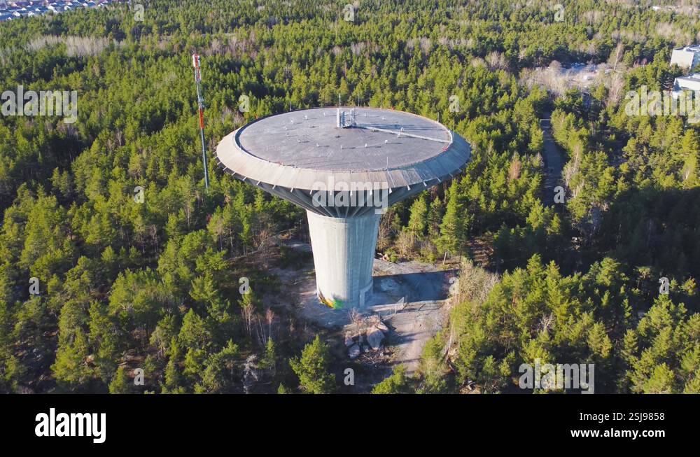 Water tower surrounded by trees. Dolly forward drone shot Stock Video ...