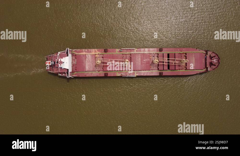 Big Bulk Carrier red cargo ship sailing along Parana River in Argentina ...