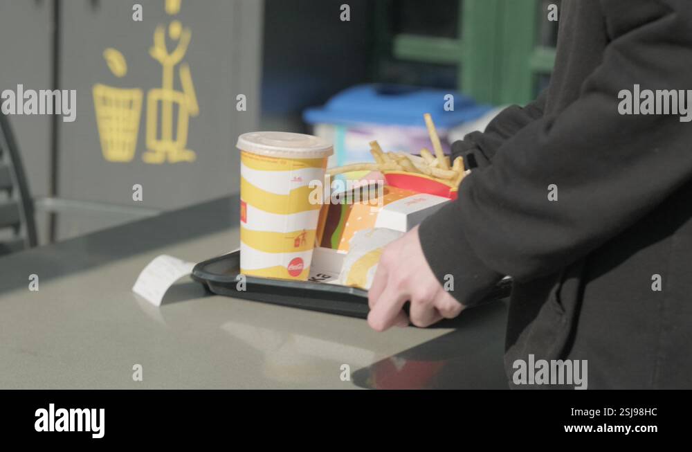 Table with trays full of fast food in McDonalds Restaurant, family ...