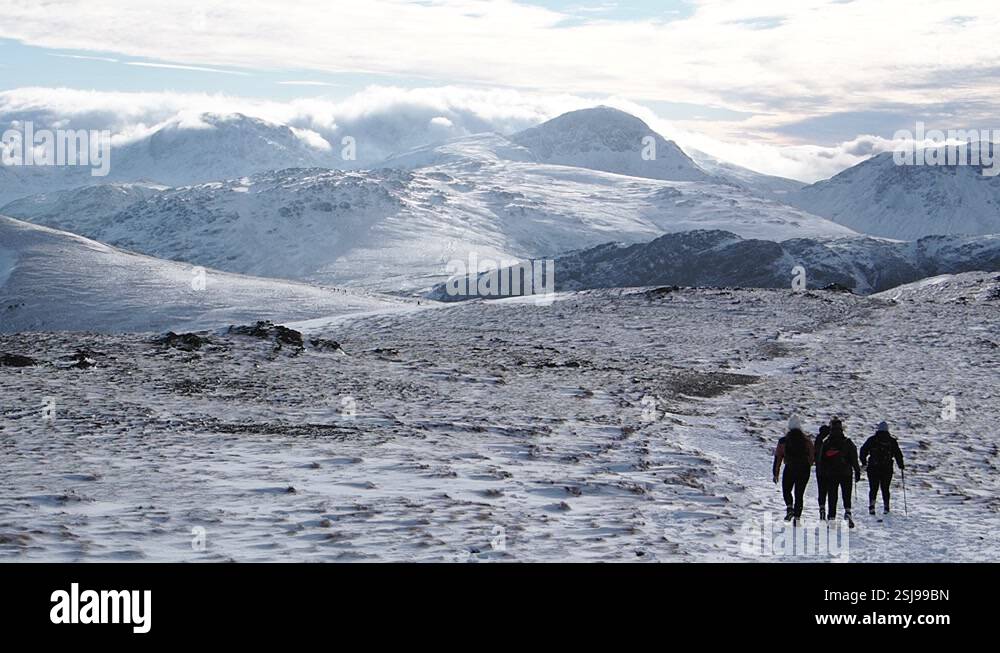 Cloud spilling over Great Gable and the Scafell range with walkers ...