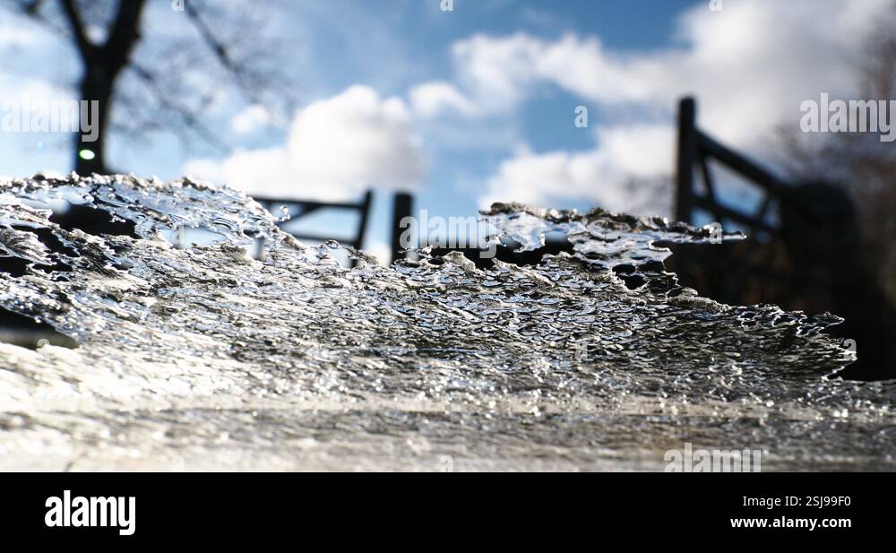 Looking up through frozen floodwater on a watermeadow in Ambleside ...