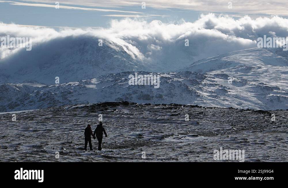 Cloud spilling over Great Gable and the Scafell range with walkers ...