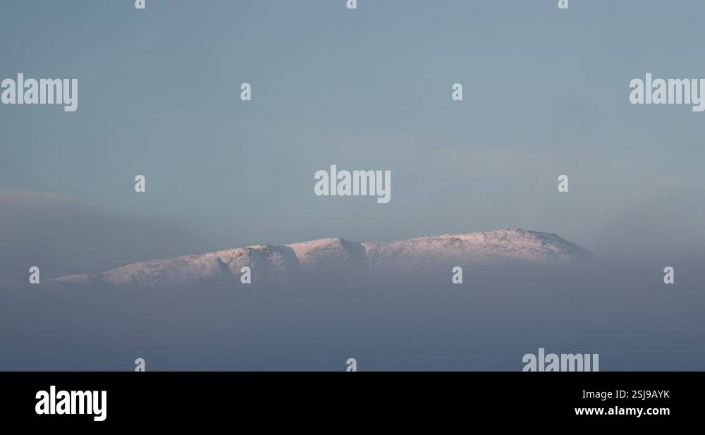 Wetherlam in Snow poking out above valley mist from Ambleside, Lake ...