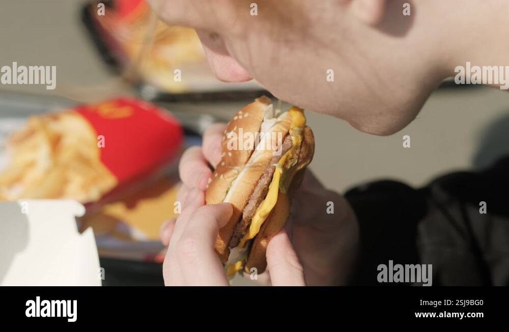 boy eating Big Mac burger in fast food McDonalds Restaurant 23.03.20 ...