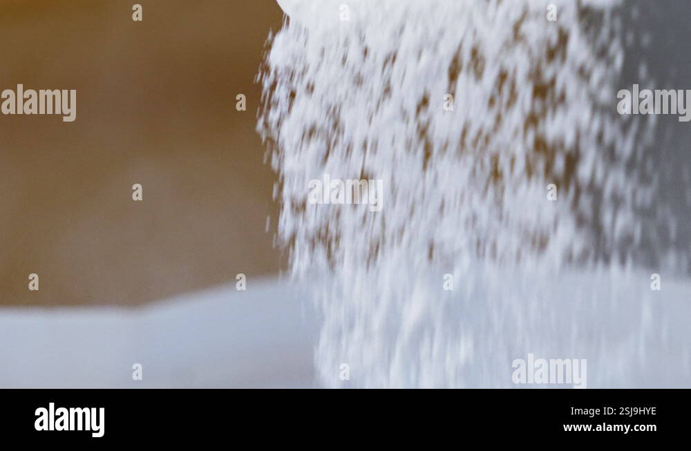Adding dry ingredients for ice cream preparation in a white bucket ...