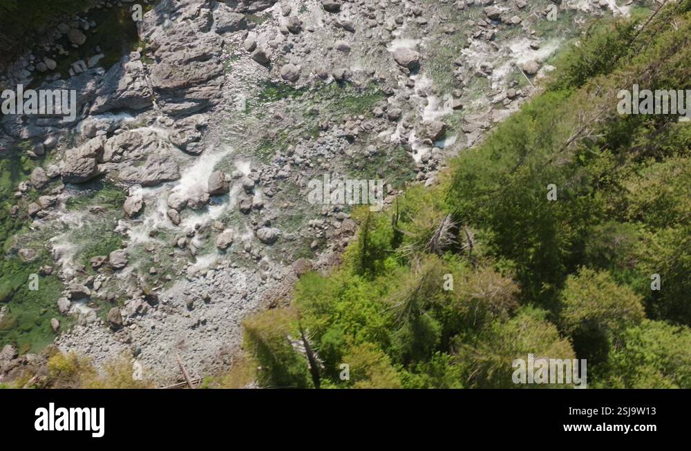 A blue green river in the forests of British Columbia Canada. A steam ...