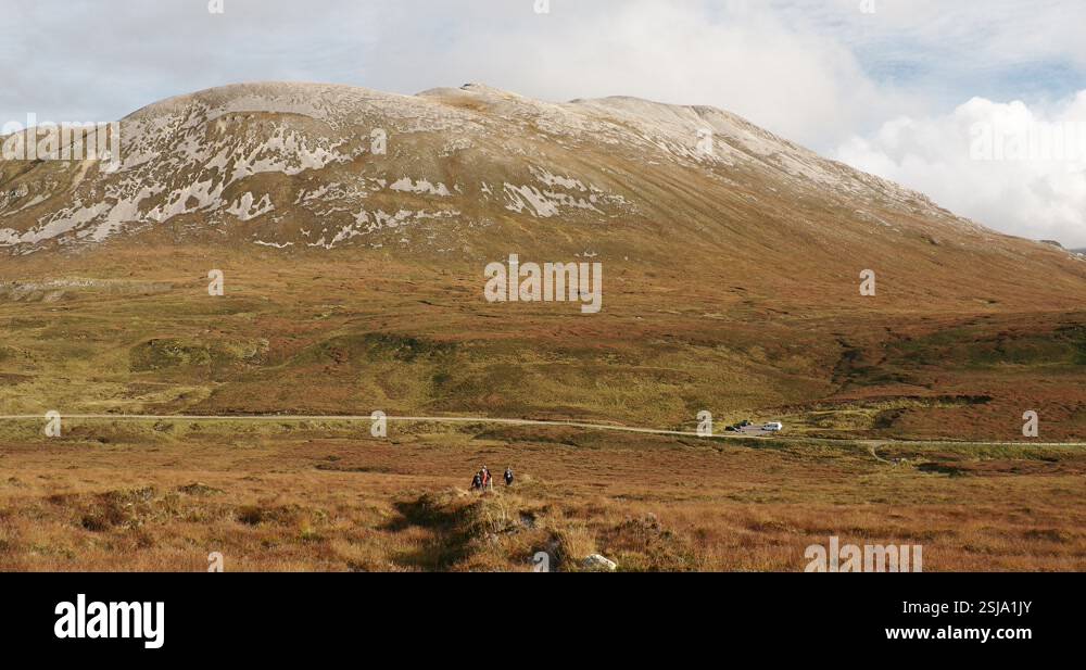Hikers descending Quinag in Assynt, Scotland, UK, looking towards Glas ...