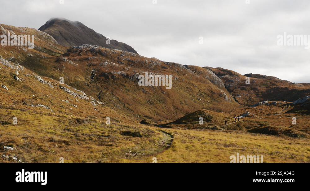 Canisp in Assynt, Scotland, UK with hikers on a path below Stock Video ...
