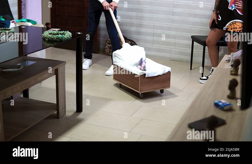 Hotel worker carrying a Mickey Mouse stuffed animal for newborn in slow ...