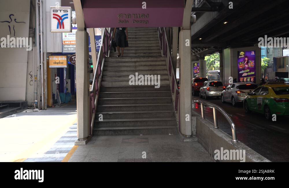 Scene of people walking past and down the stairs of Sala Daeng BTS ...