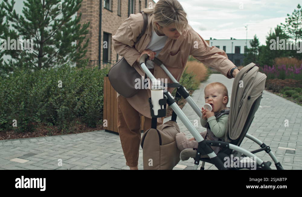 Young Mother Fixing Stroller Hood Stock Video Footage - Alamy