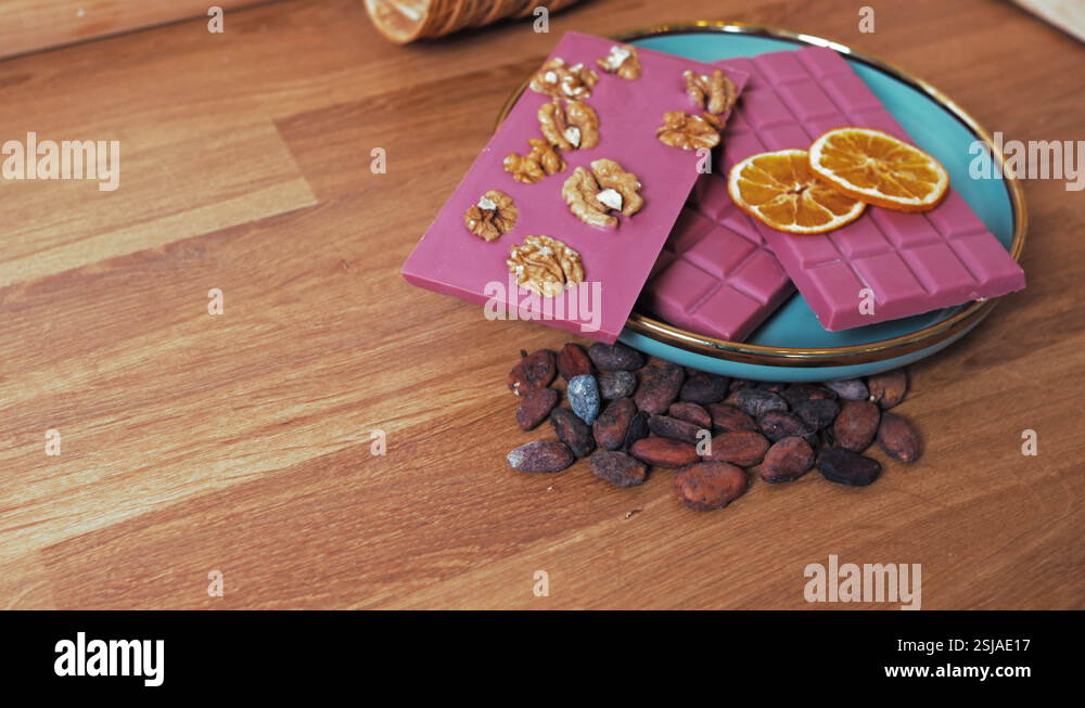 Ruby chocolate bars with orange slices and walnuts - Fruit and nut chocolate bar Stock Video ...