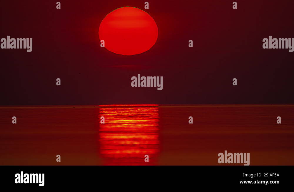 Close-up of red sun rising from the sea horizon, Timelapse Stock Video ...
