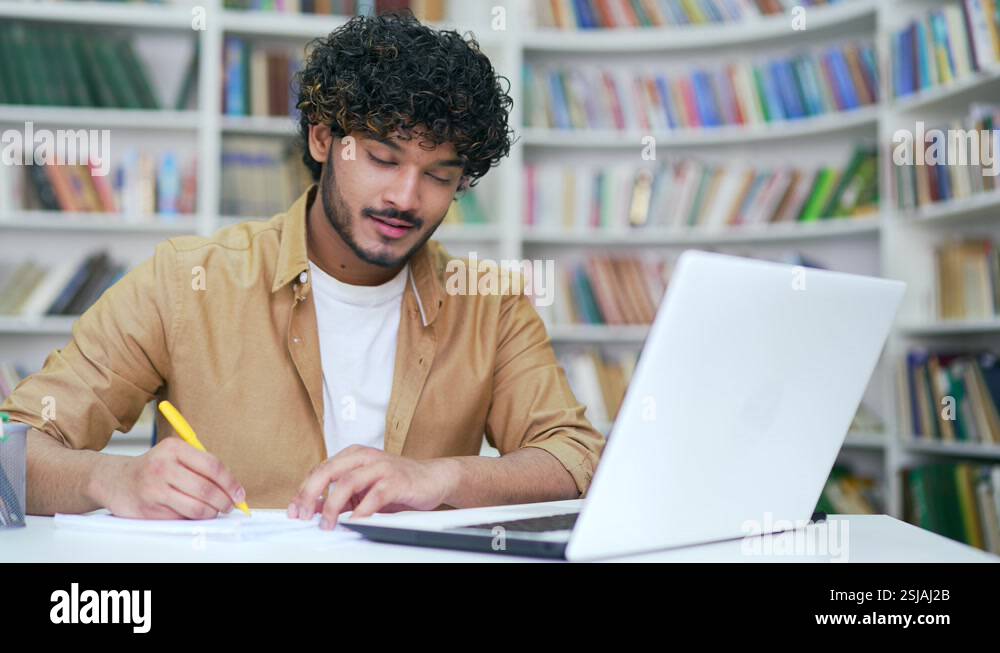 Young student listens to online e-learning, video course in campus ...
