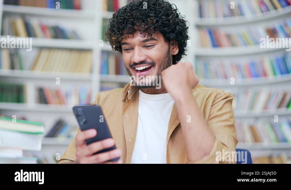 Close up Happy excited student celebrating success reading good news on ...