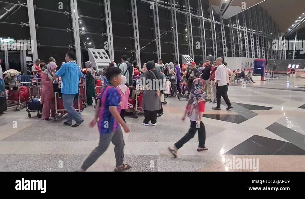 Muslim men and women waiting in a queue at a crowded airport Stock ...