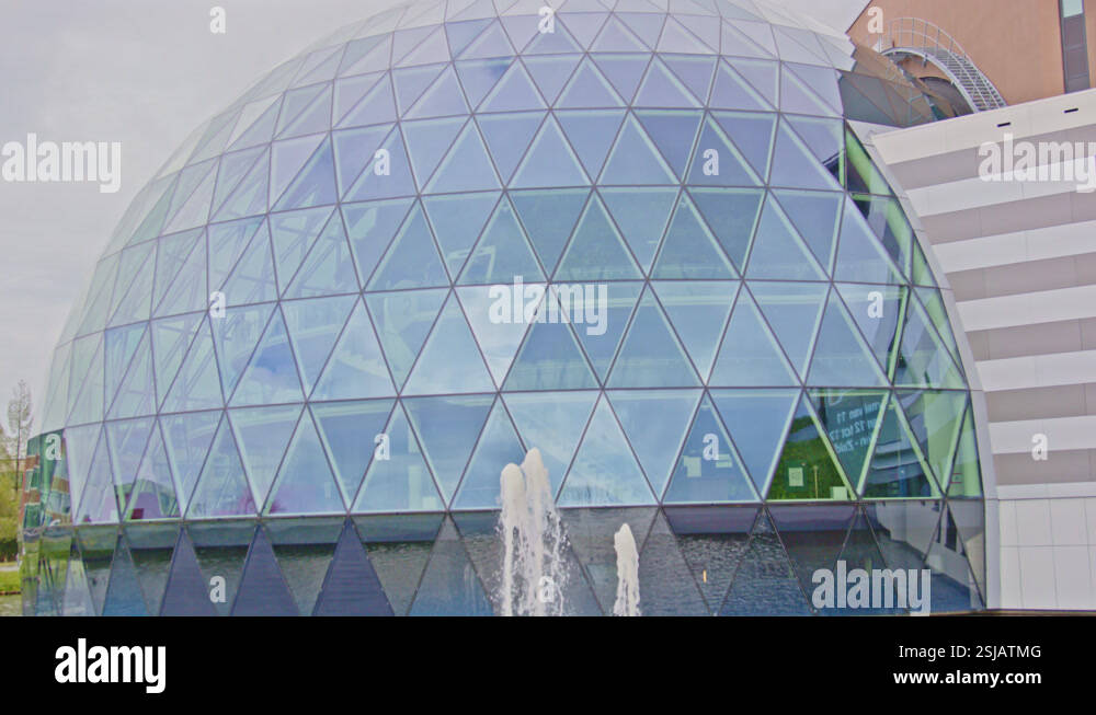 Tilt down of the beautiful AFAS theater building with fountains in ...