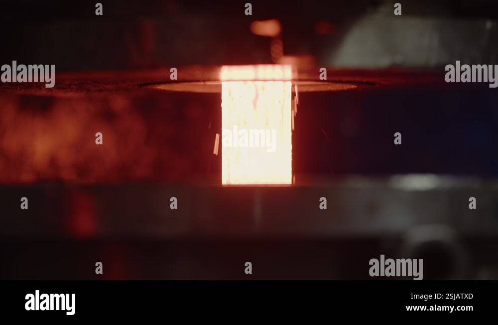 Hydraulic press slowly flattens red-hot metal workpiece with a fall-off ...