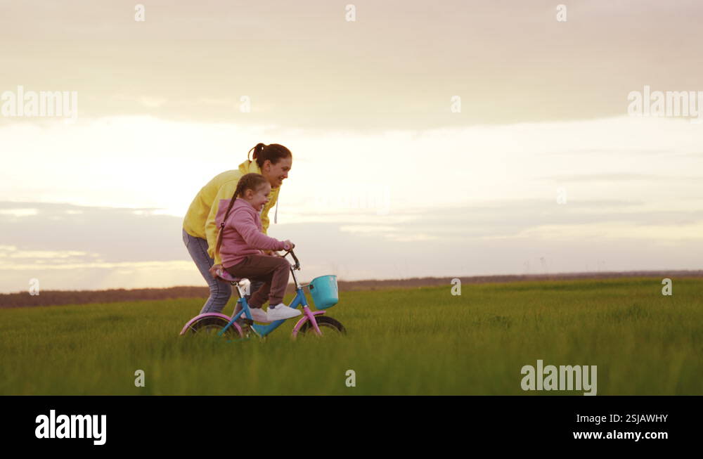 Little chilt learns ride bike field park sunset dot happy family ...