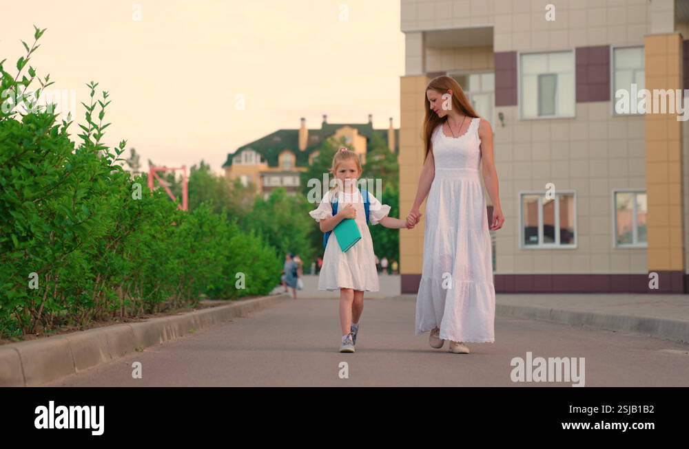 Happy family, girl, mom, go to school together. Concept of childrens ...