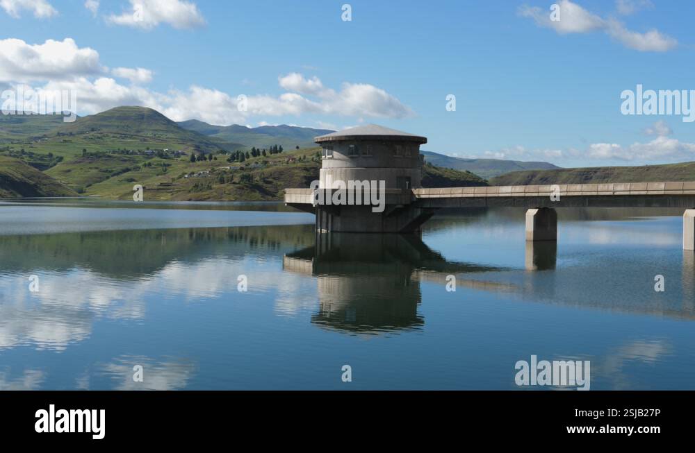Water intake tower on calm picturesque hydro dam reservoir, blue sky ...