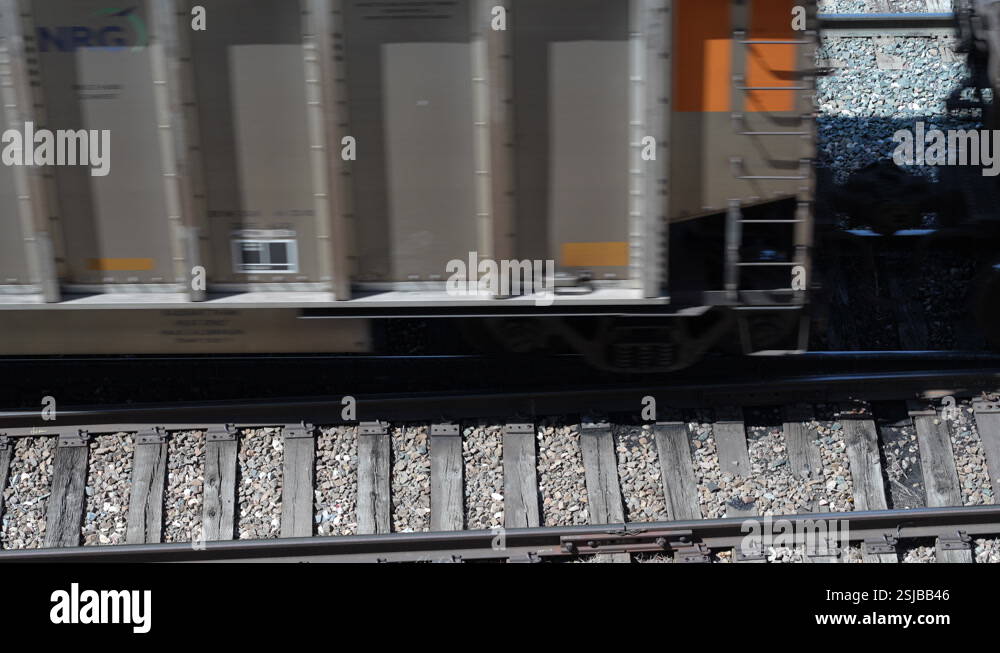 Rail freight transported in hopper cars on railway, top angle close-up ...