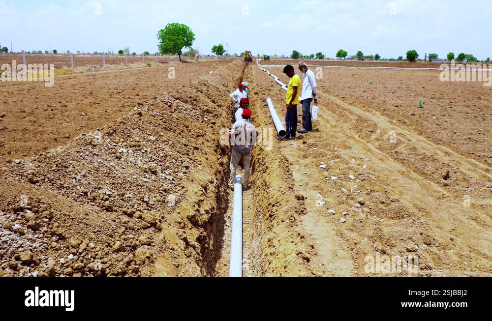 many labor fittings water pipeline at day time, aerial camera zoom in ...
