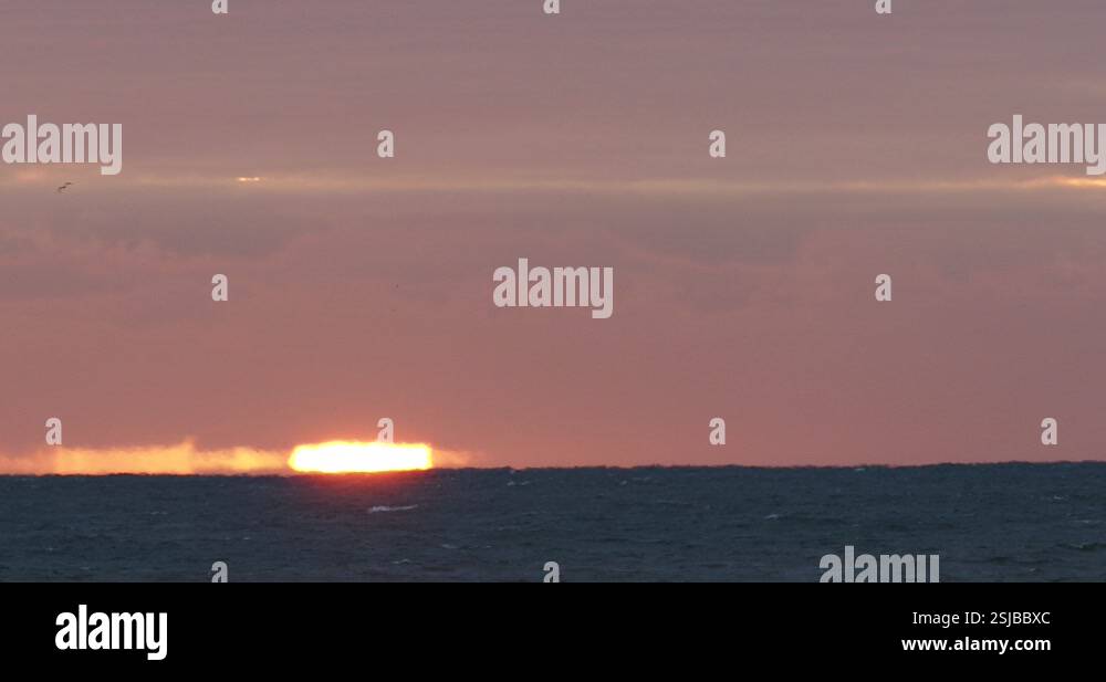 The sun rising at dawn over the North Sea from Beadnell, Northumberland ...