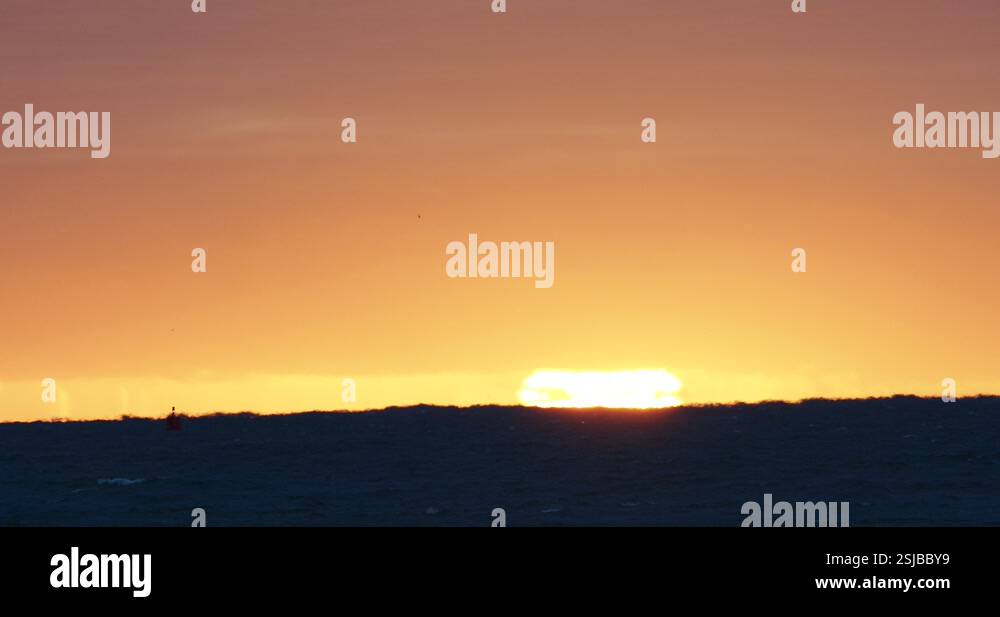The sun rising at dawn over the North Sea from Beadnell, Northumberland ...