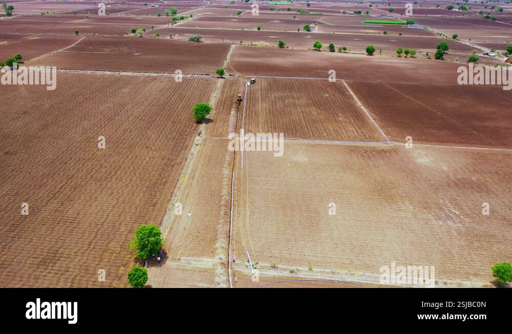 Aerial Cinematic shot of excavation digging in the farm land for the ...