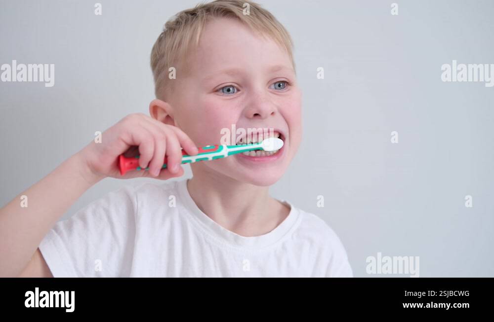 cute little blonde boy smiling and brushing teeth. Children Health care ...