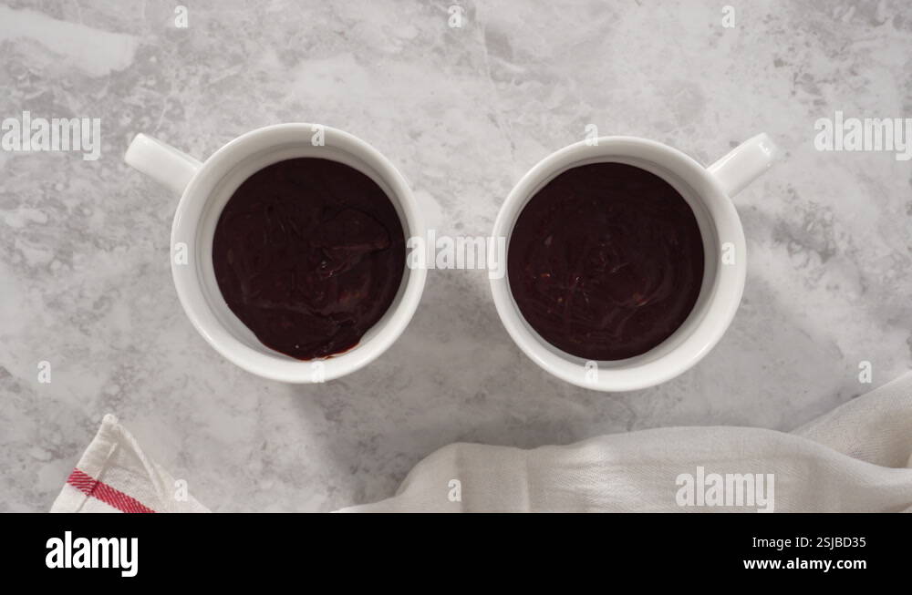 Flat lay. Step by step. Pouring chocolate cake batter into the cups to ...