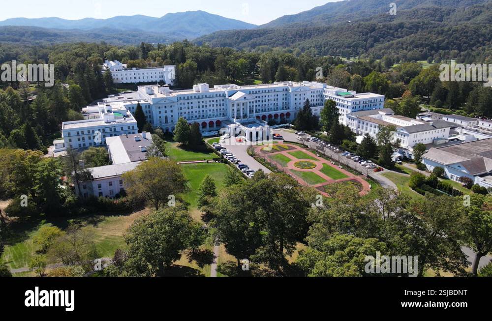 Aerial rotating parallax over trees of The Greenbrier Hotel during ...