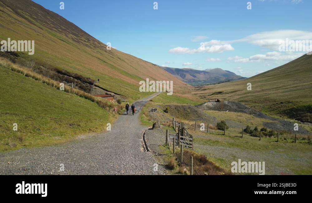 Walkers on valley floor track on sunny day at Coledale Beck in the ...